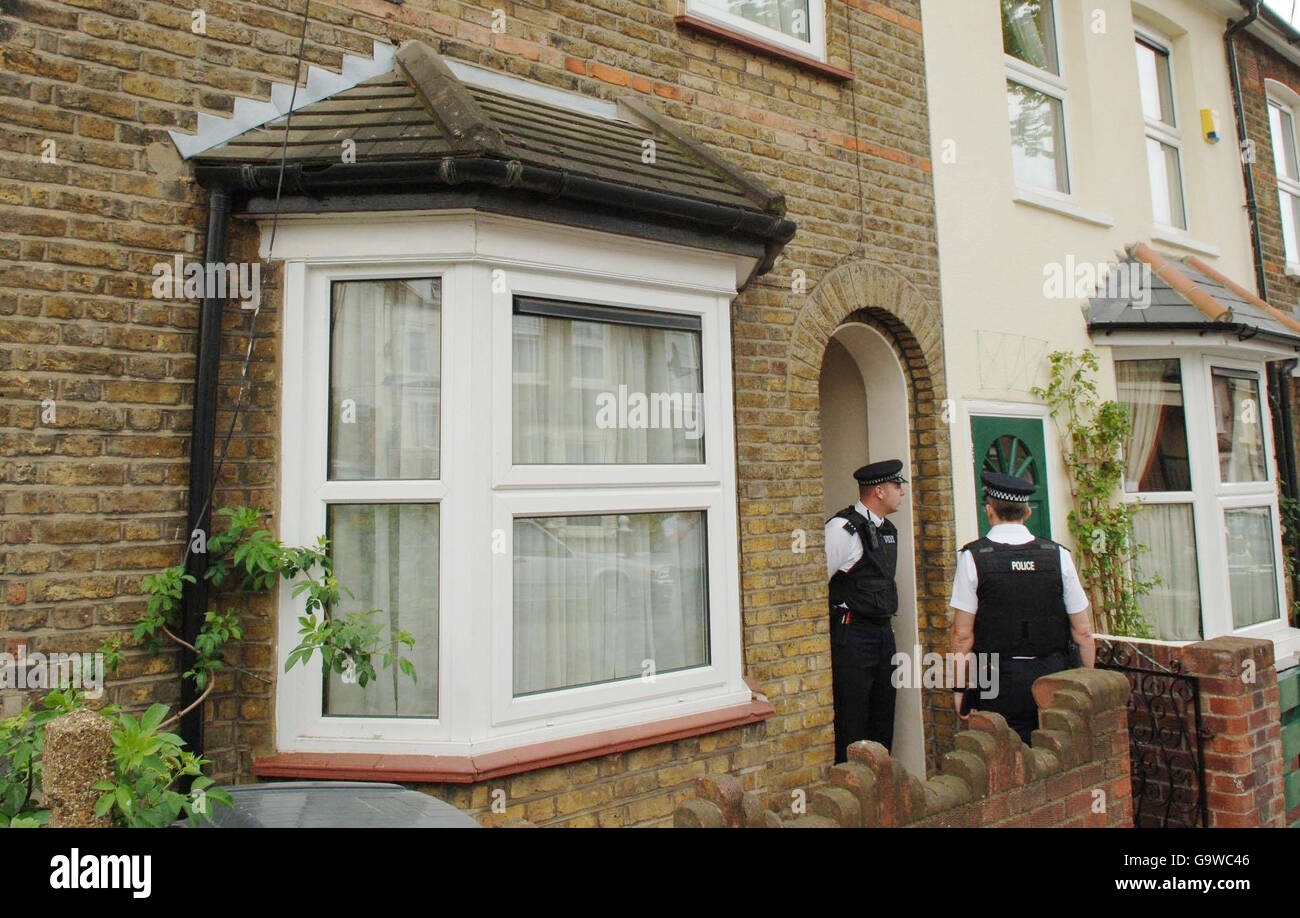 Police officers stands outside a house in Leyton, east London Stock ...