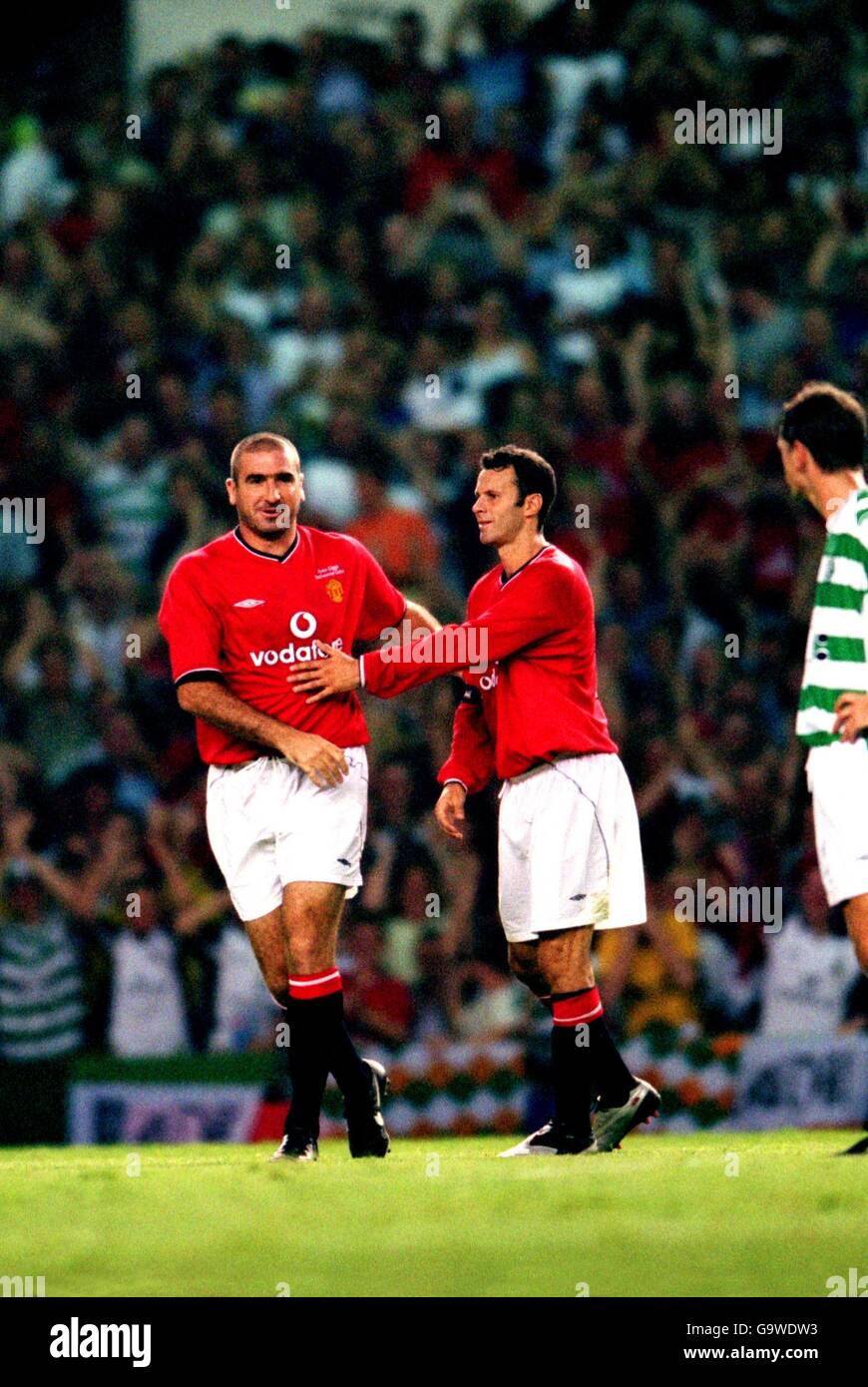 Manchester United's Ryan Giggs (r) welcomes surprise guest Eric Cantona ...