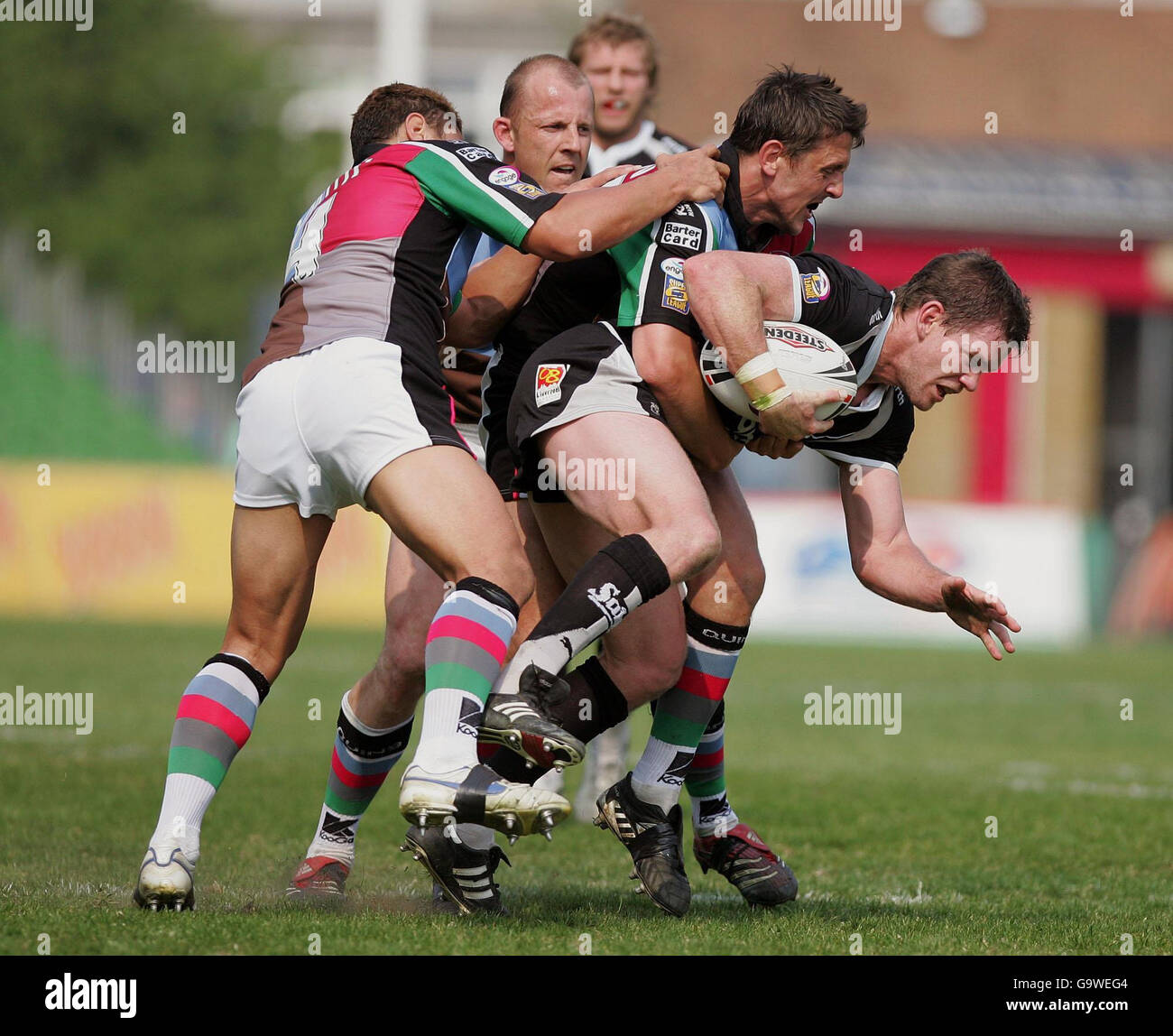 St Helens' Matt Gidley is tackled by members of Harlequins during the ...