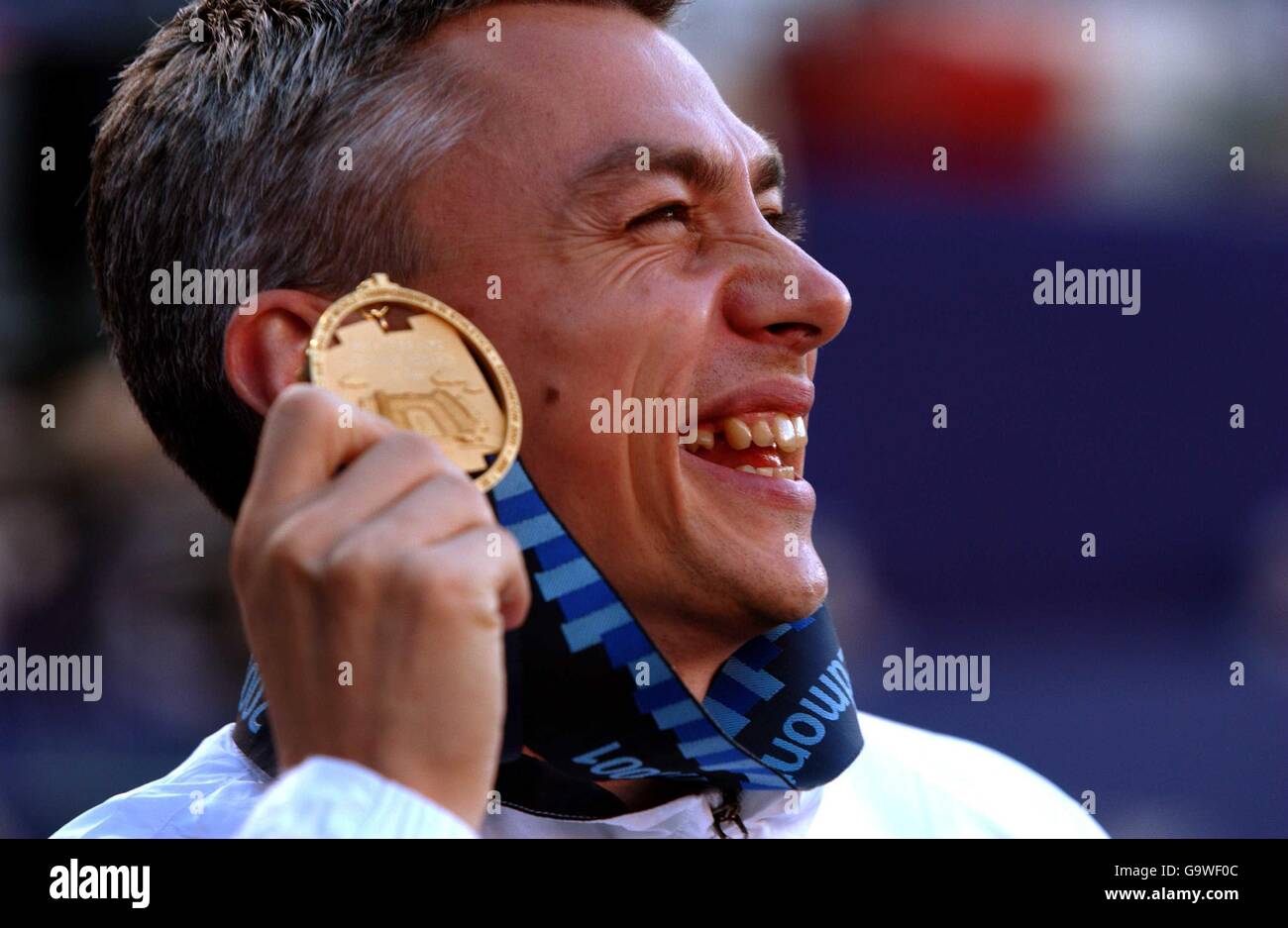 Great Britain's Jonathan Edwards is all smiles with his gold medal won ...