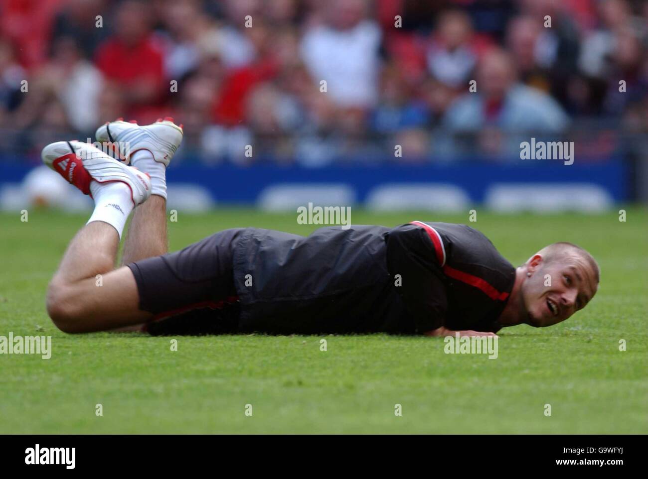 Manchester United's David Beckham has trouble keeping on his feet ...