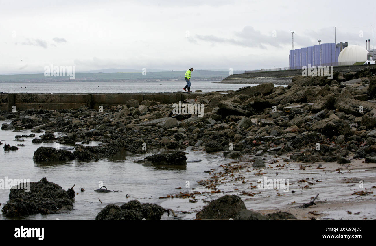 A Scottish Water official examines Seafield beach and the outflow pipe ...
