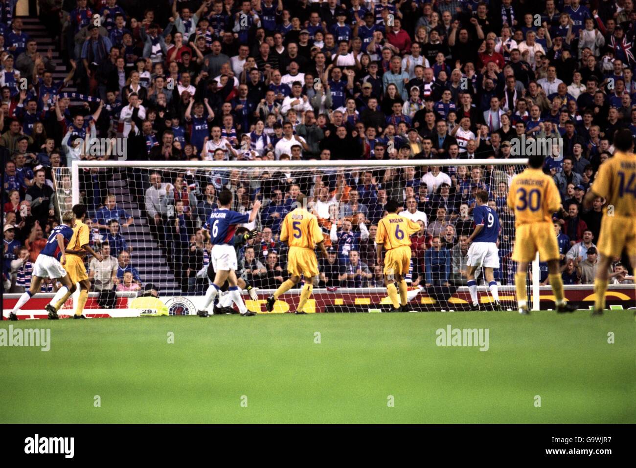 Rangers' Tore Andre Flo (R) scores their first goal of the game as ...