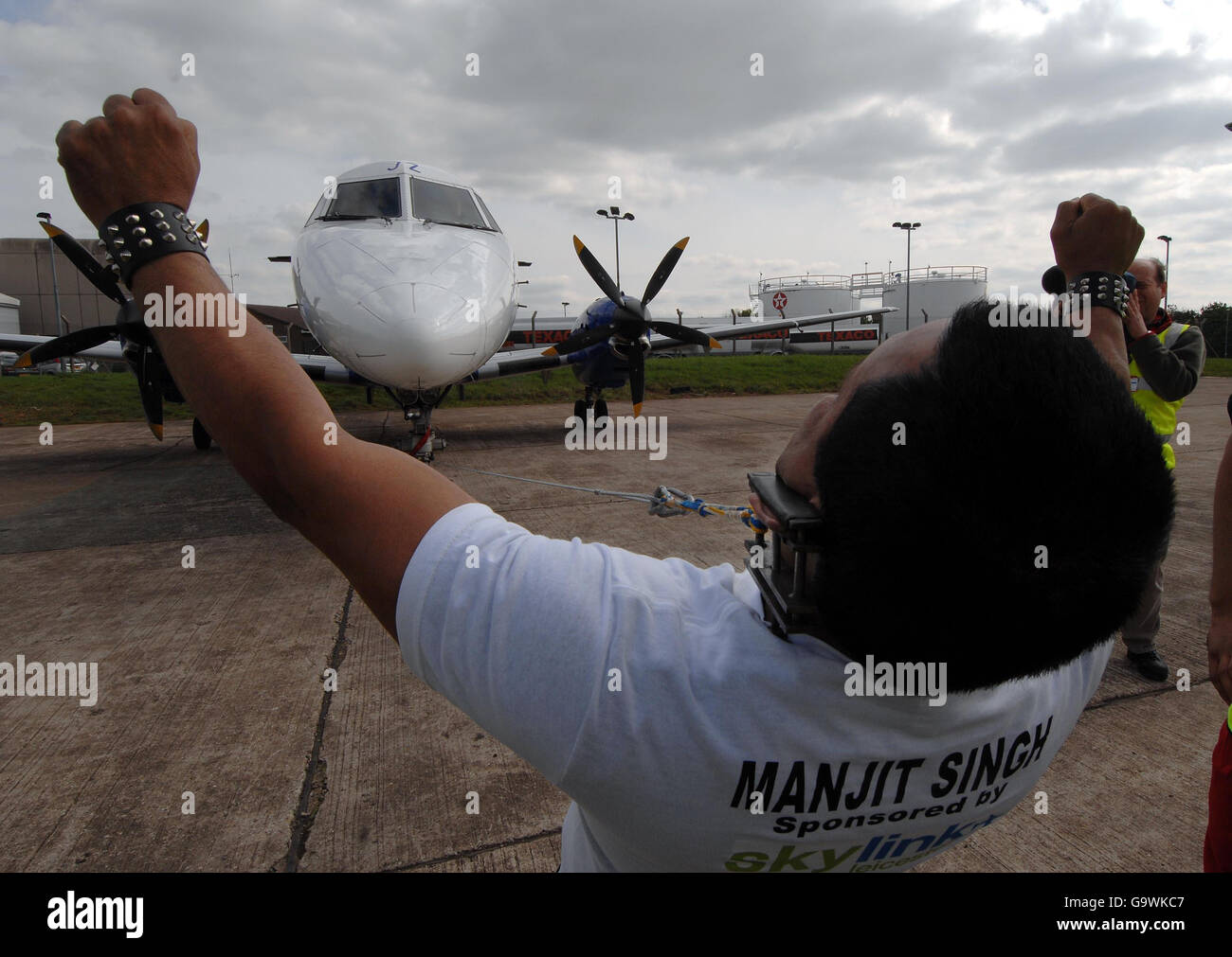 Man breaks record by pulling aircraft with his ears Stock Photo - Alamy