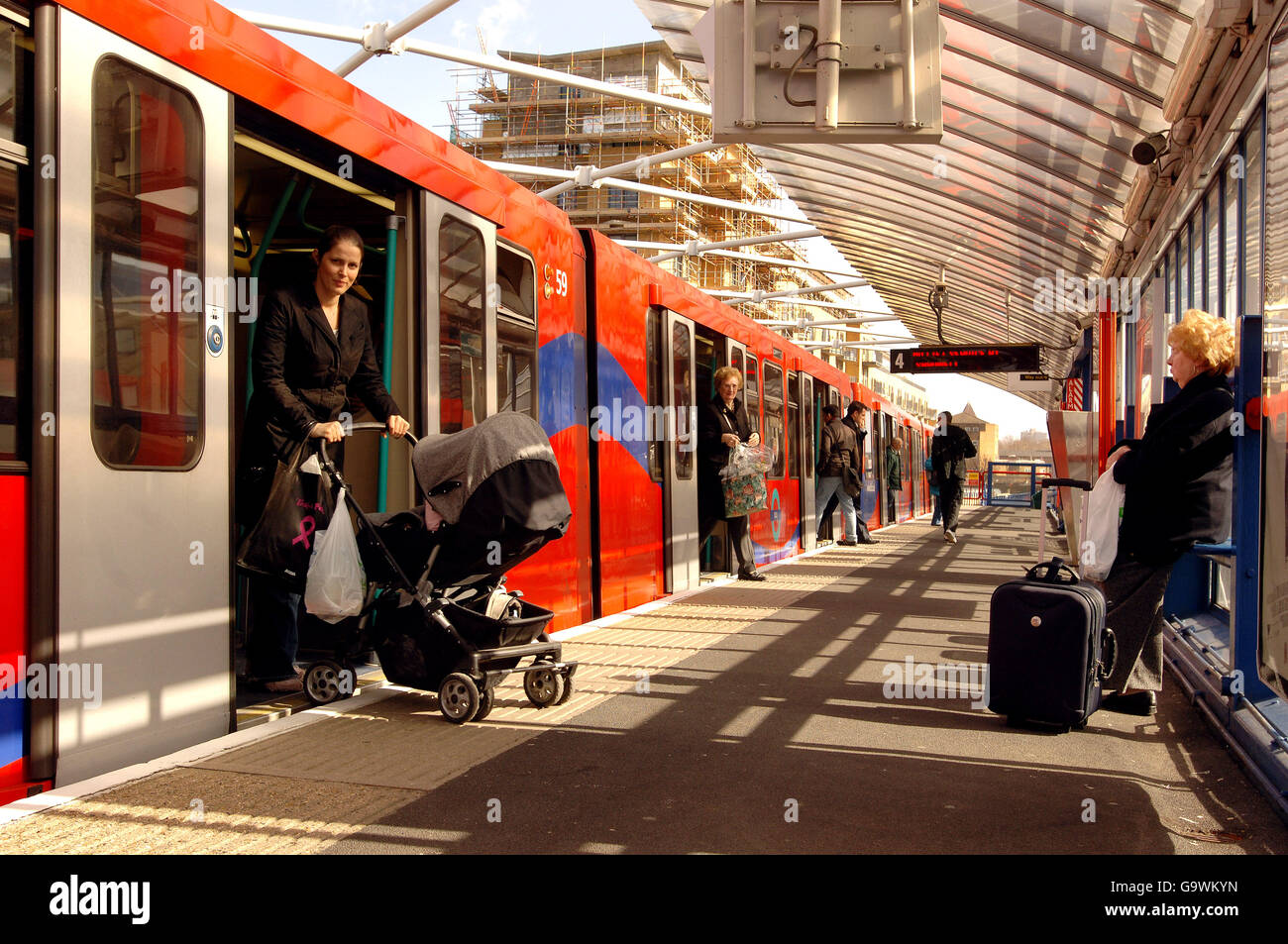 DLR Transport stock. PAssengers alight from a train on the he Docklands ...