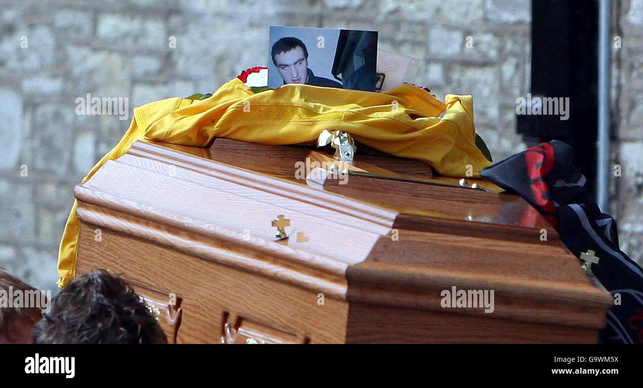 The coffin of Adrian Dunne is carried from St Cormac's Church ...