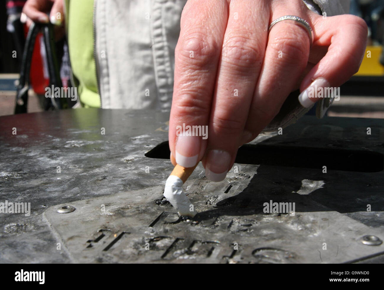 Northern Ireland smoking ban. A cigarette is stubbed out in Belfast ...