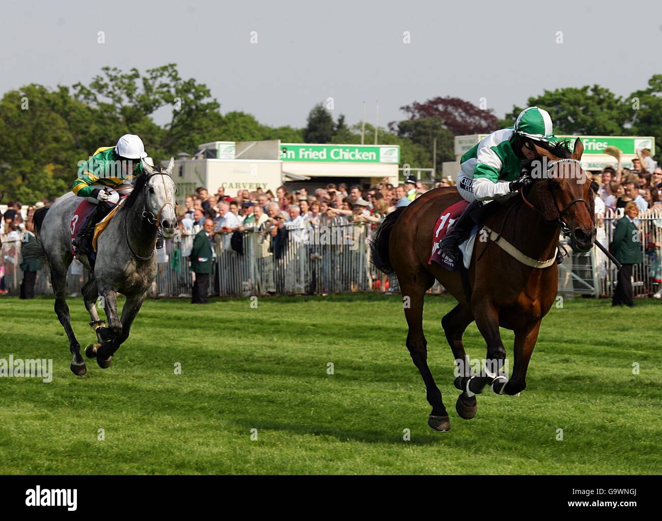 Hot Weld (right) ridden by jockey Graham Lee approaches the finishing ...
