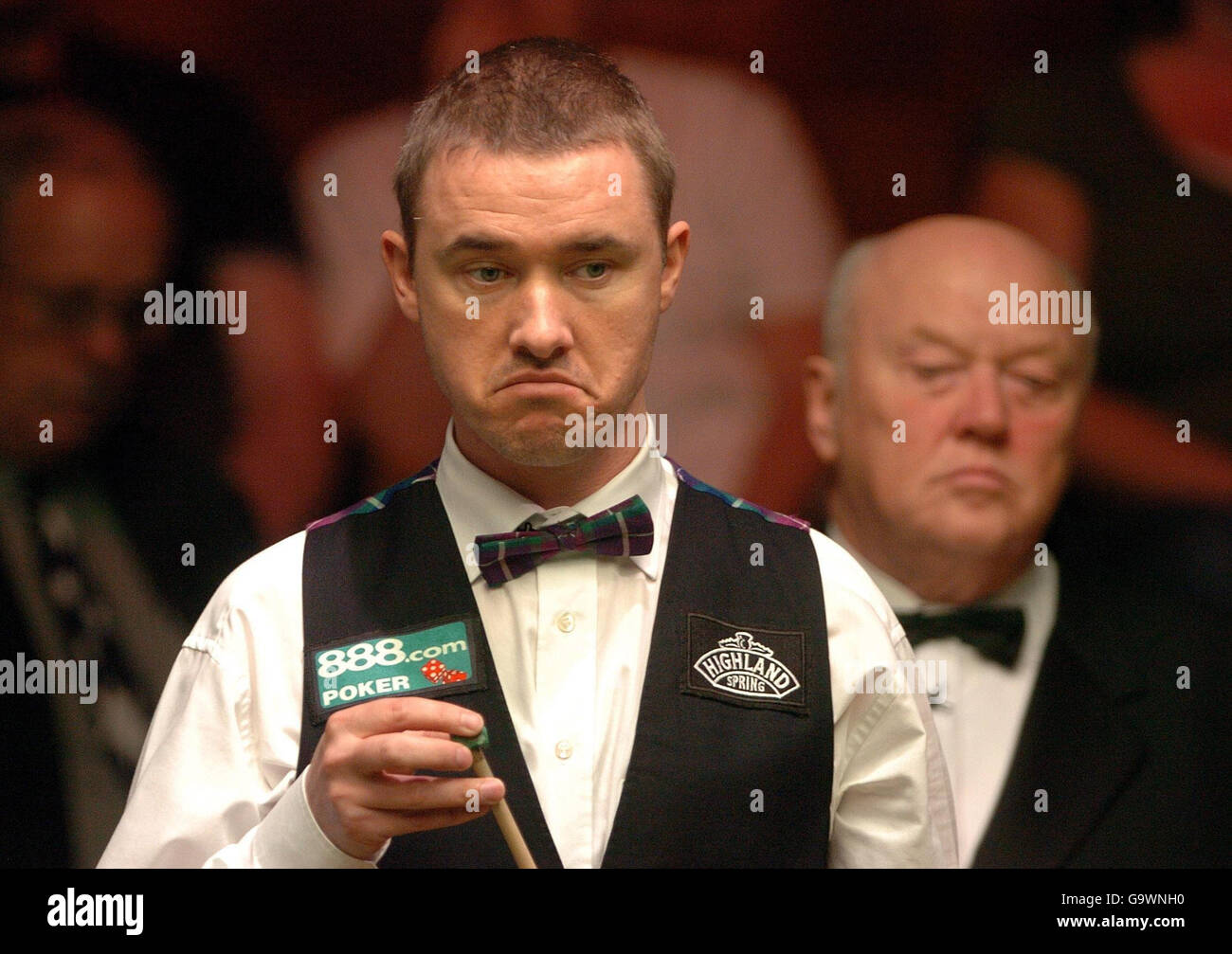 Scotland's Stephen Hendry looks unhappy at the table as referee Pete ...