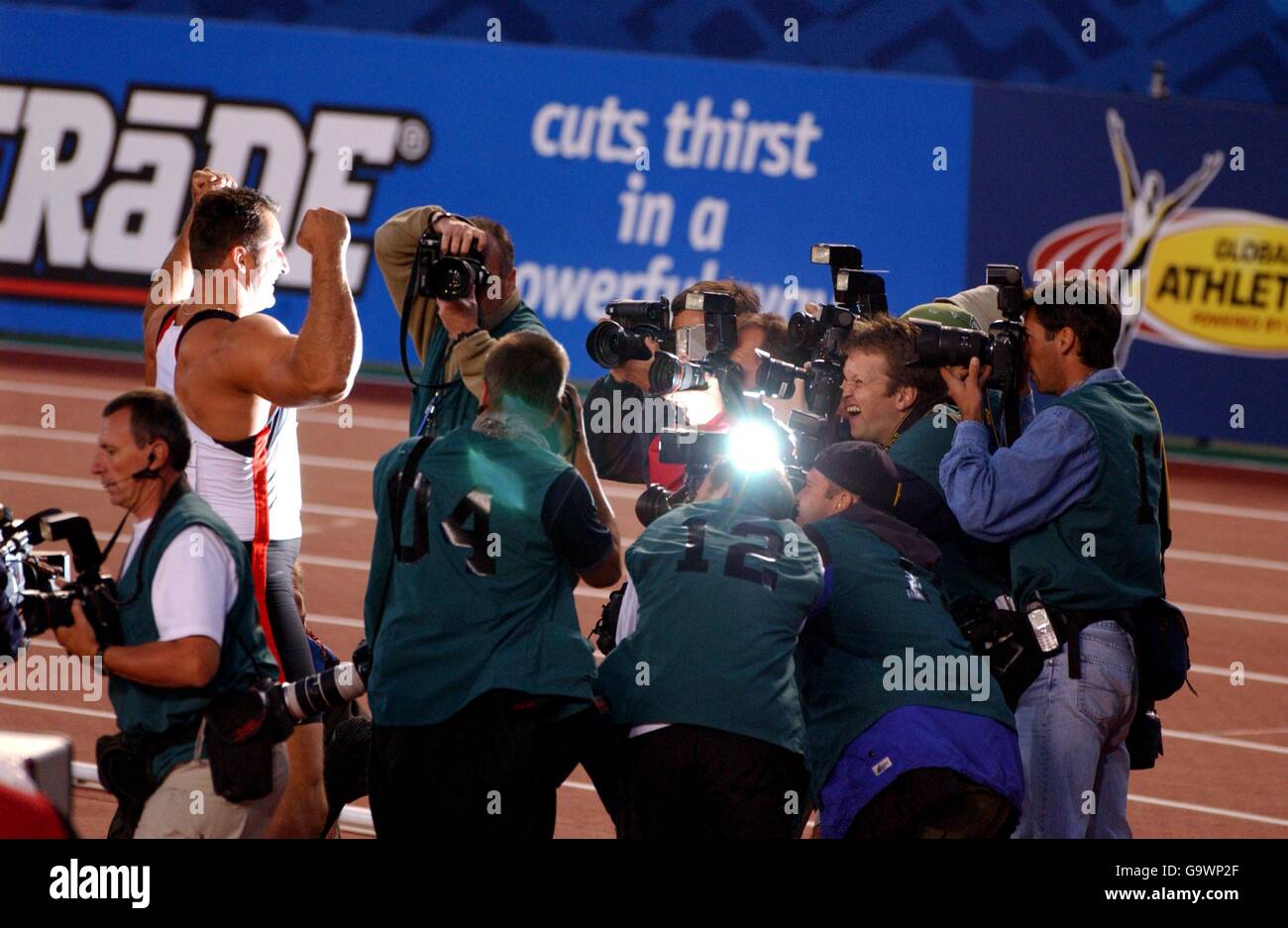 Germany's Lars Riedel hams it up for the infield photographers after ...