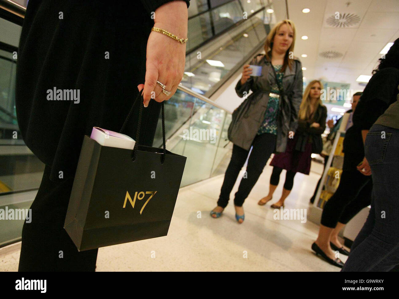 Shoppers in Boots flagship store in Oxford Street, central London queue ...