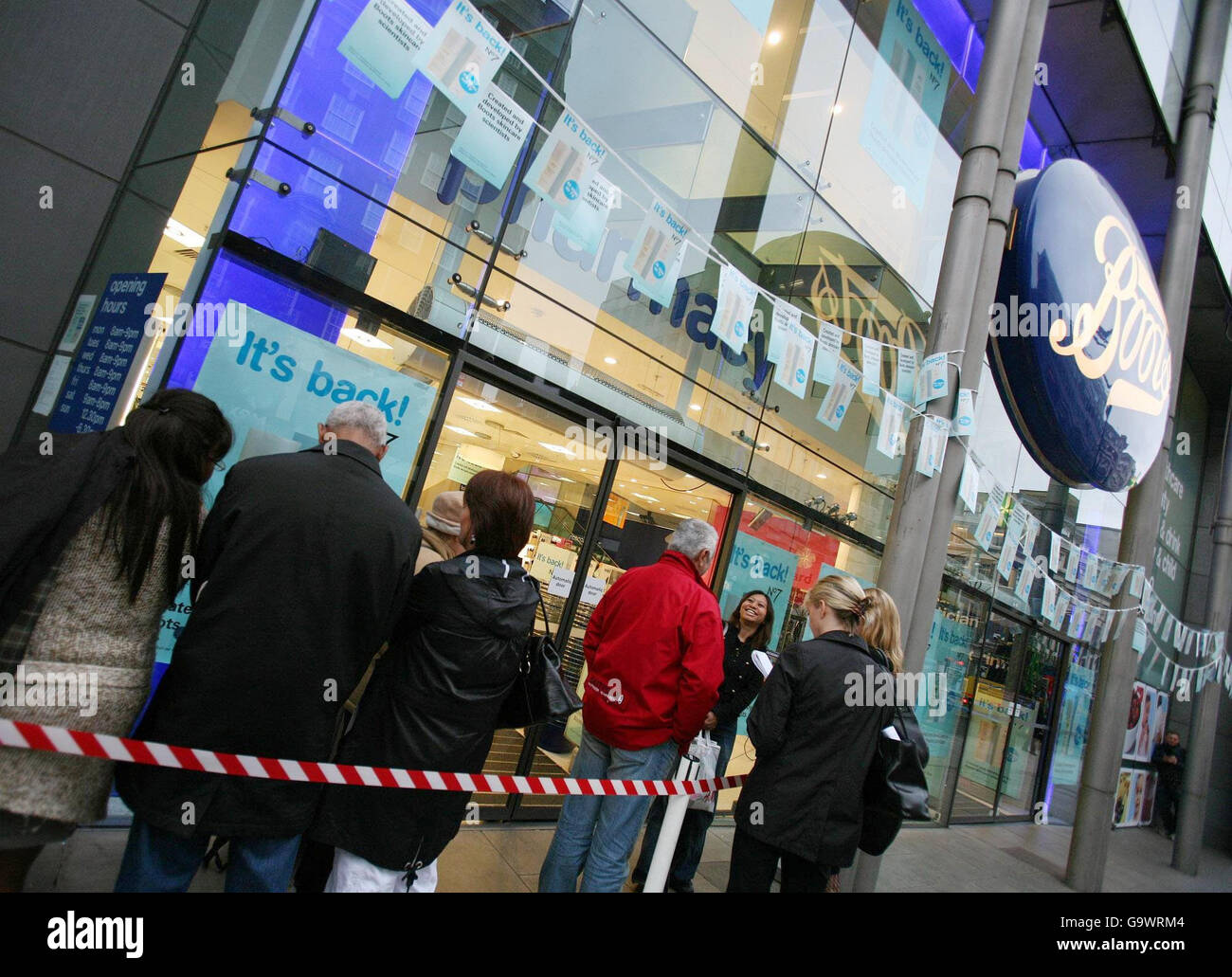 Shoppers queue outside the boots flagship store in oxford street hi-res ...