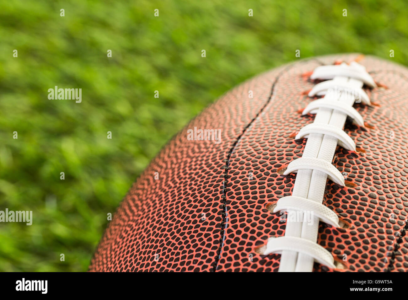 American Football Close up on on green grass Stock Photo - Alamy