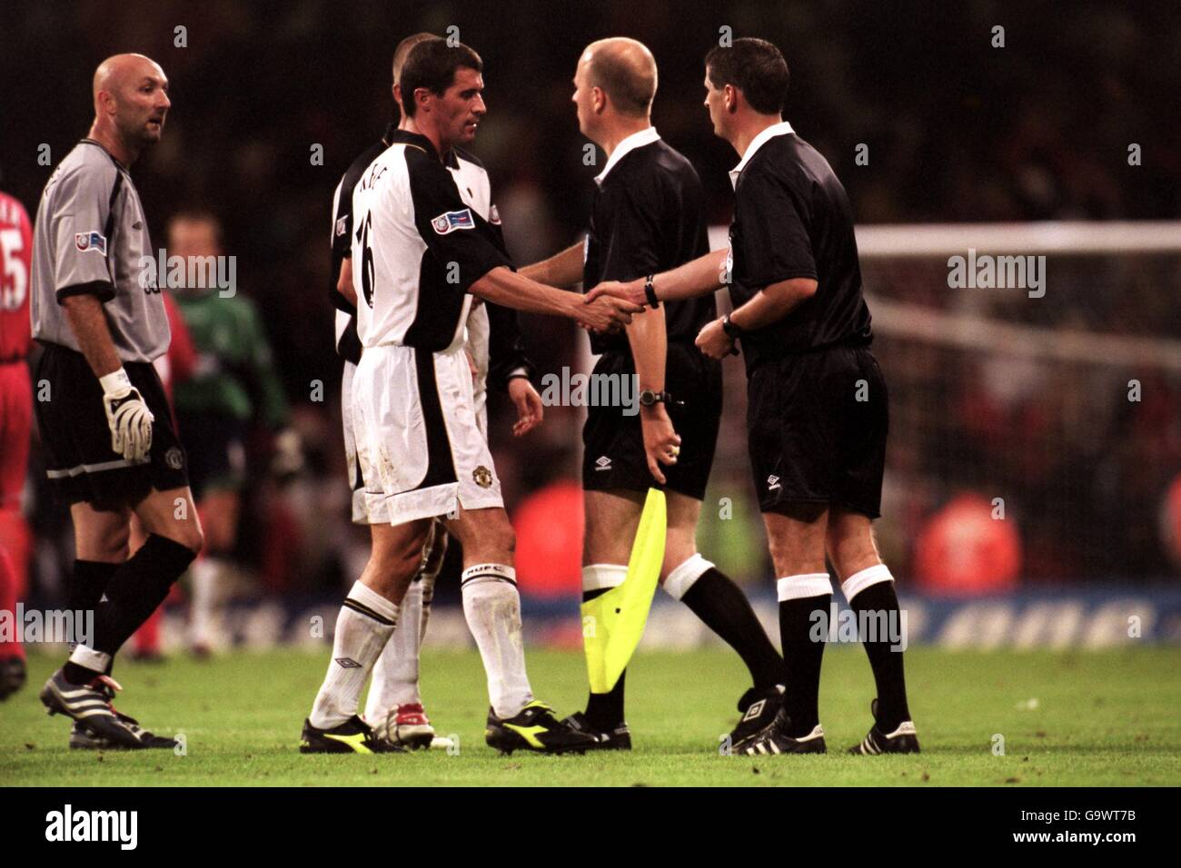 Manchester United captain Roy Keane (c) shakes hands with referee Andy ...