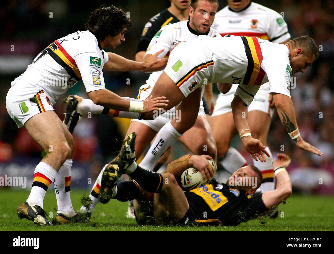 Bradford's Matt Cook and Terry Newton tackle Leeds' Jamie Thackray ...