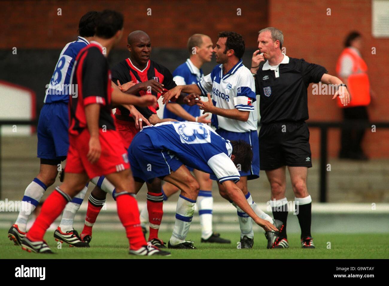 Referee Neale Barry (r) looks on as Fulham's Barry Hayles (second l ...