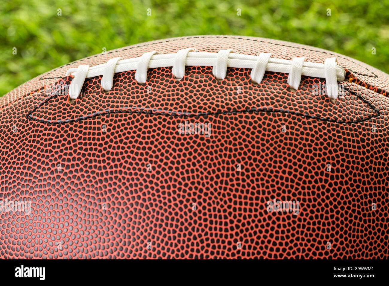 American Football Close up on on green grass Stock Photo - Alamy