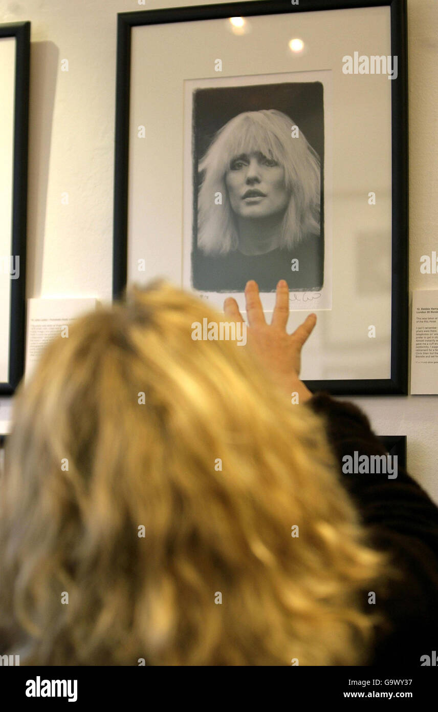 Guests study the prints at private view of the photographs of music ...
