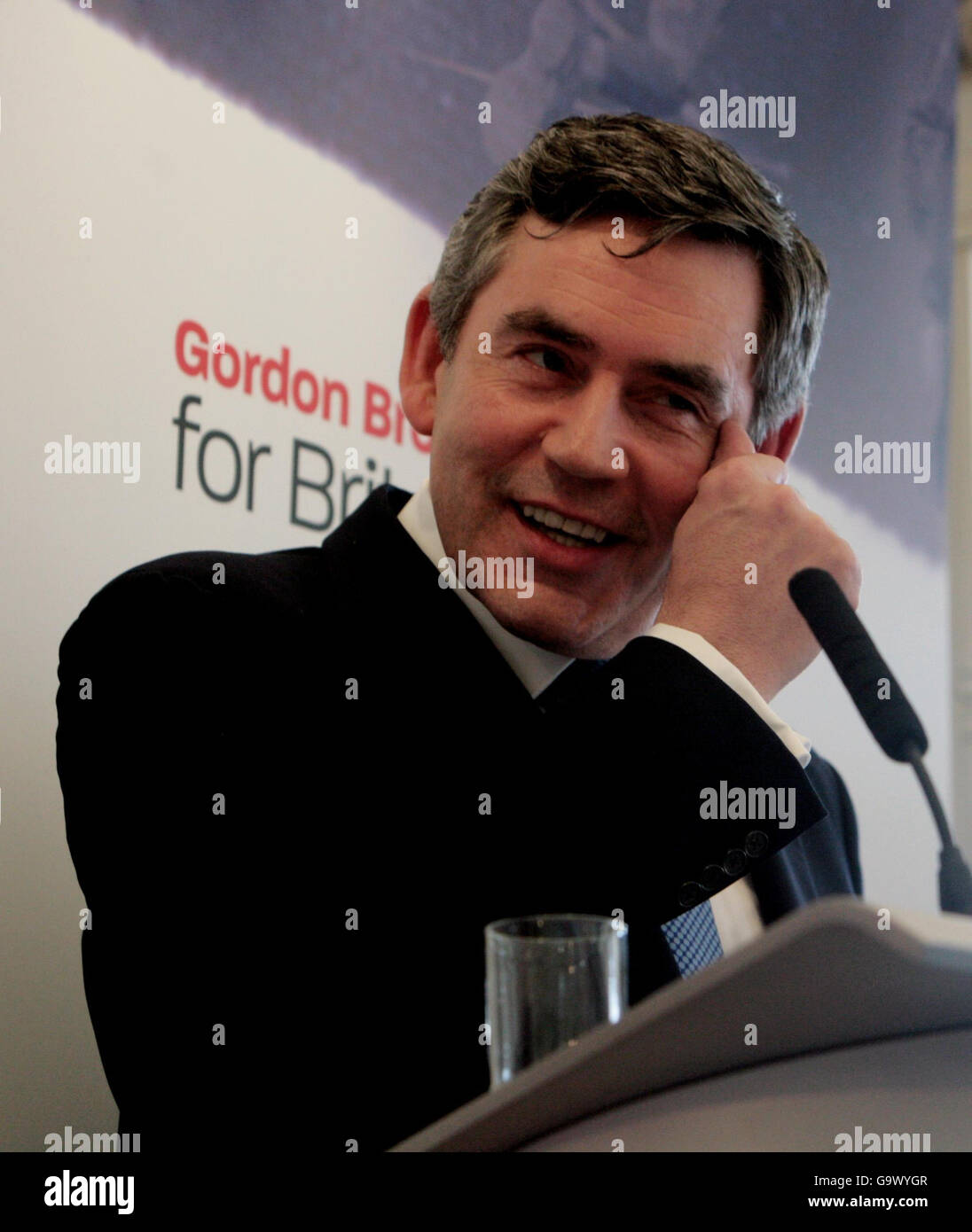 Half length mid top lectern smiling mic mike microphone england hi-res ...