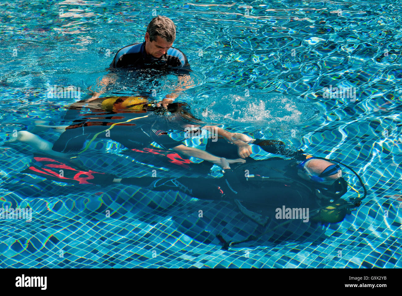 Handicapped diver with dive instructor Stock Photo - Alamy