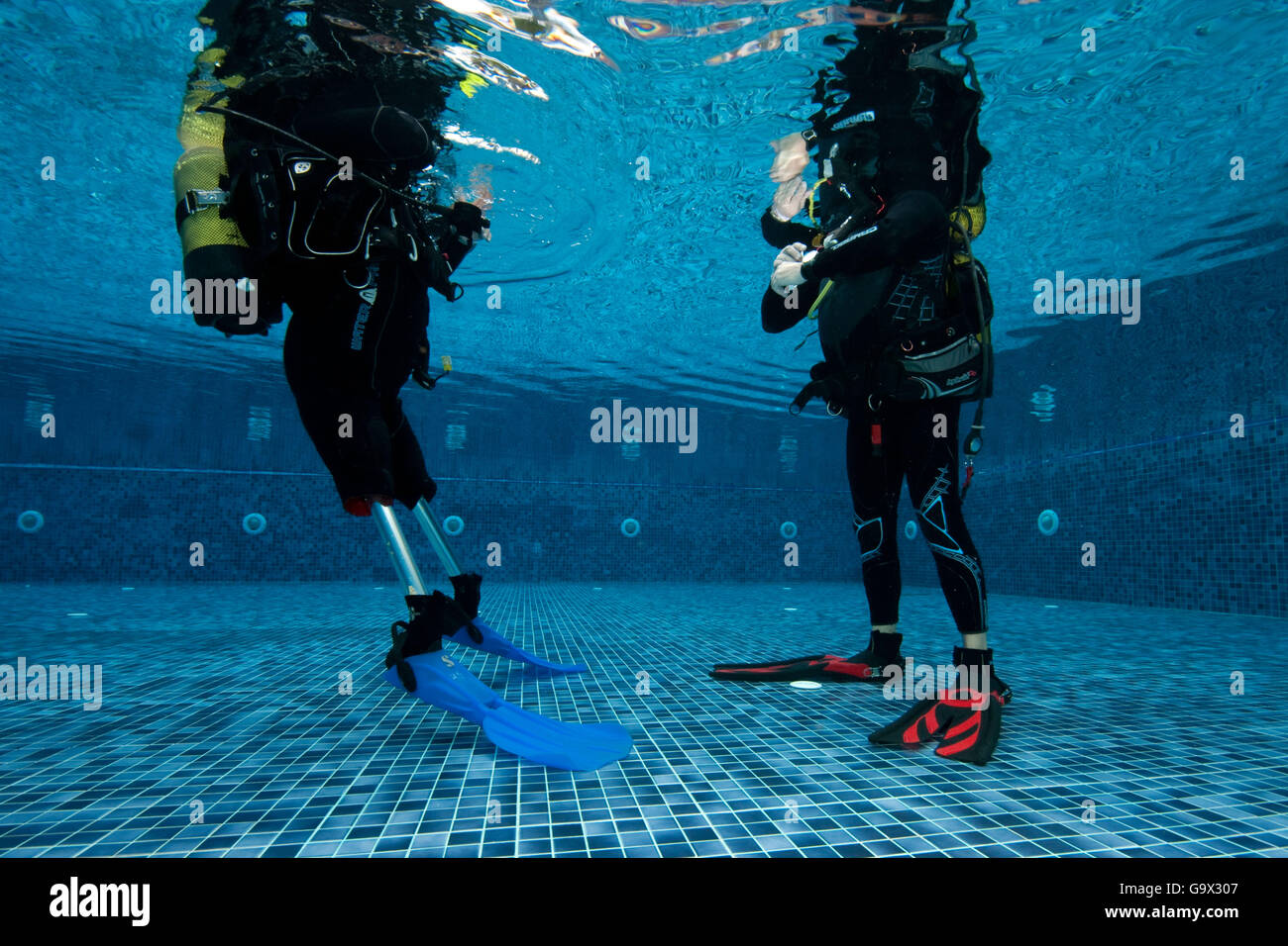 Handicapped diver with leg prothesis and dive instructor Stock Photo ...