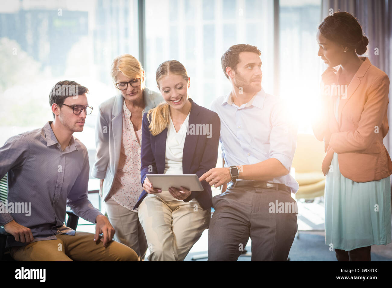 Business people interacting using digital tablet Stock Photo - Alamy