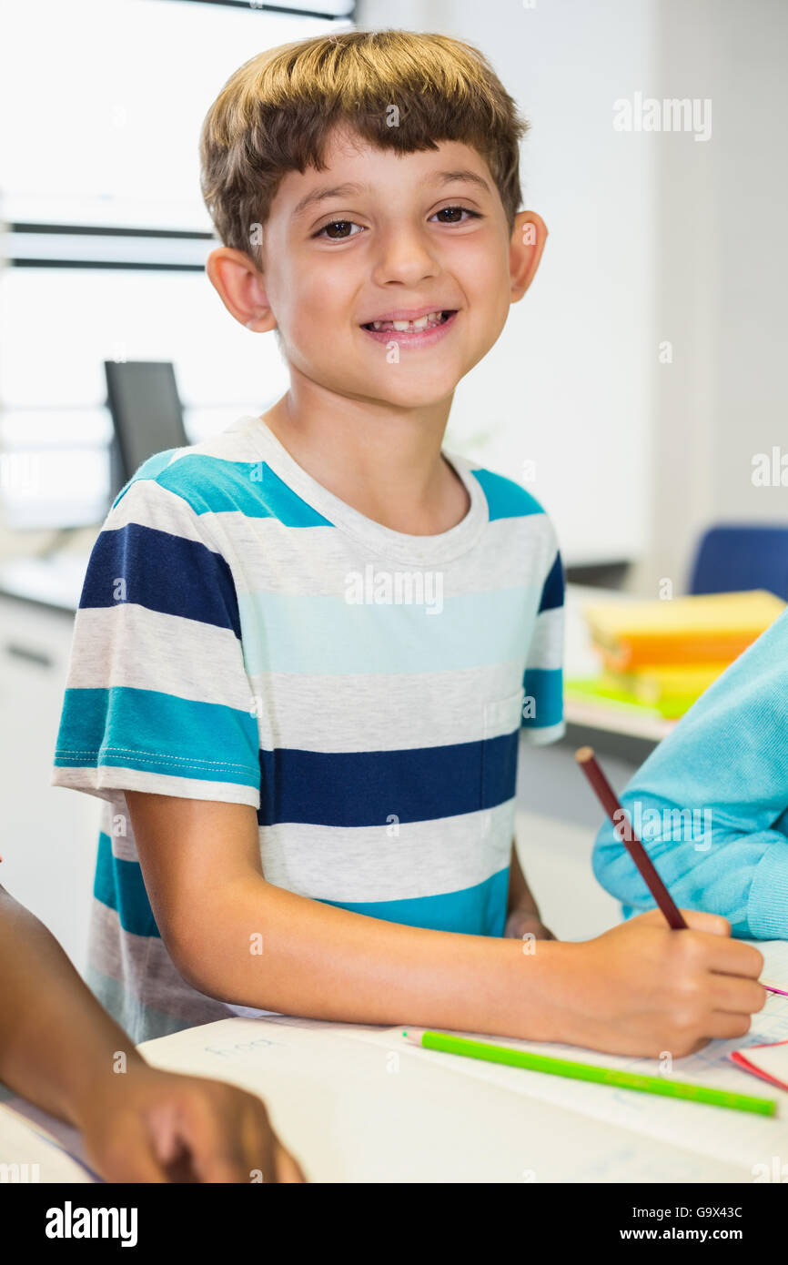 Portrait of schoolboy smiling in classroom Stock Photo - Alamy