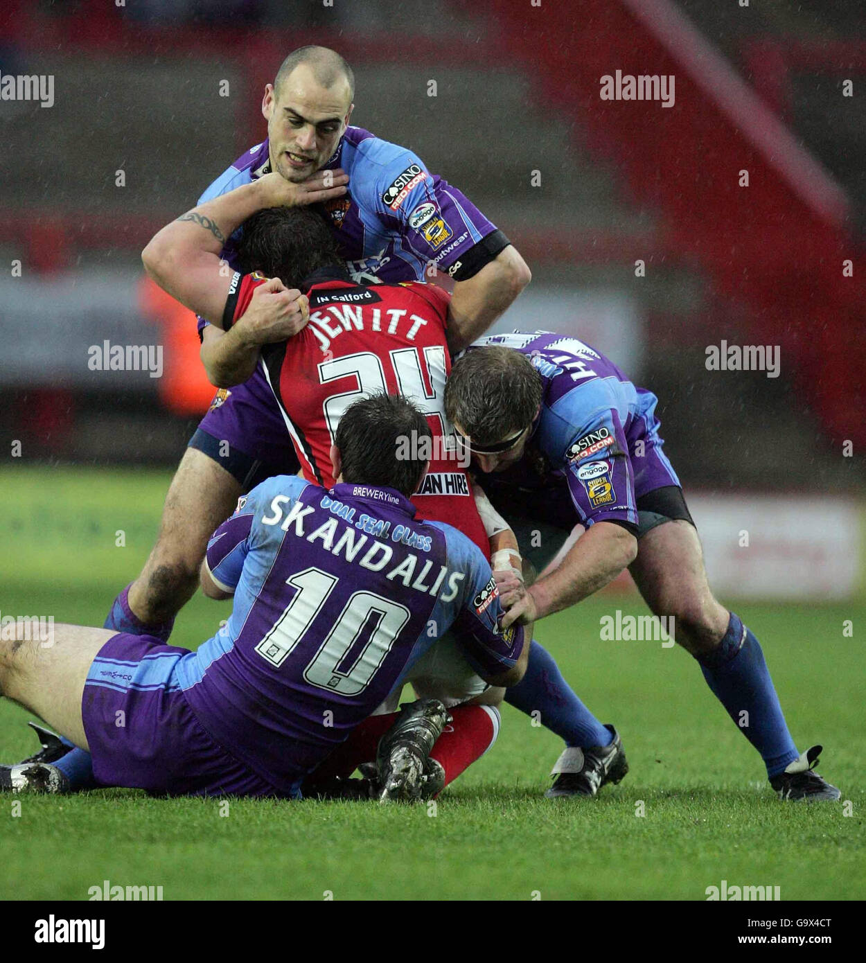 Huddersfield's Andy Raleigh (top) and John Skandalis bring down Salford ...
