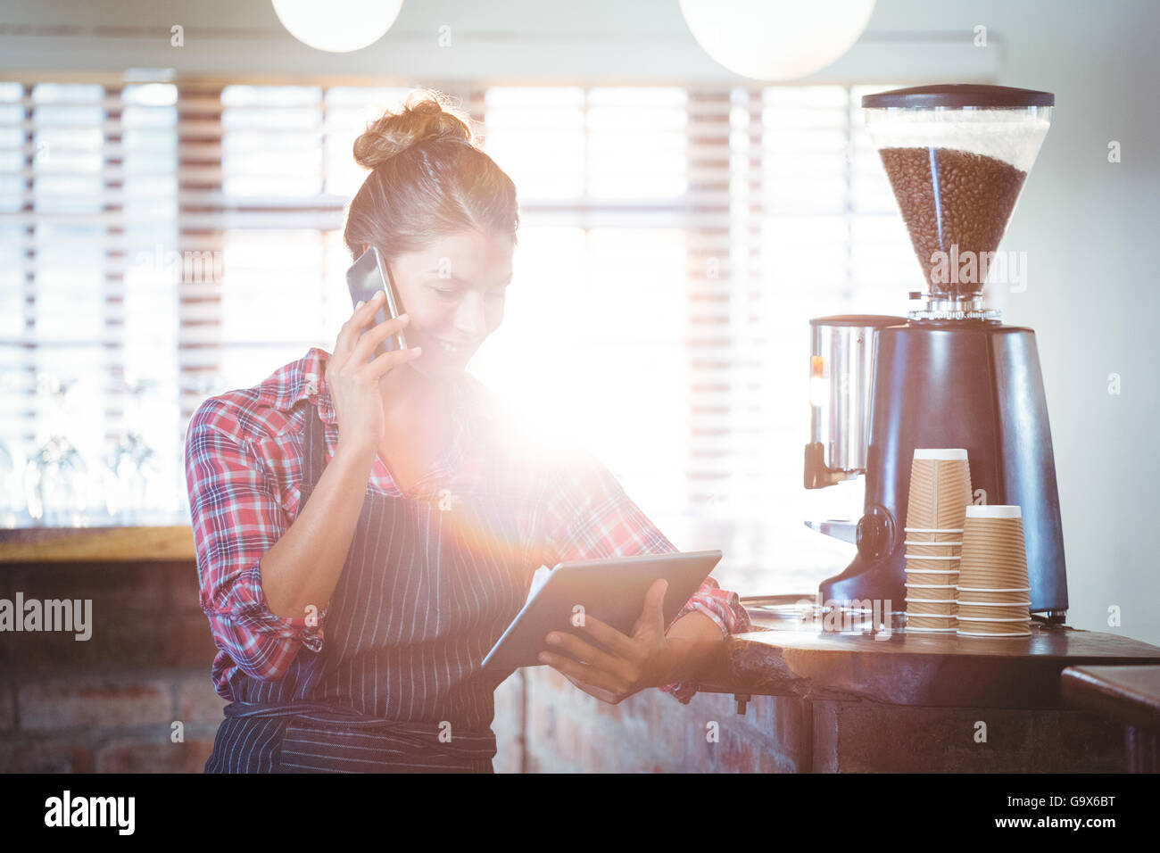 Waitress making a phone call Stock Photo - Alamy