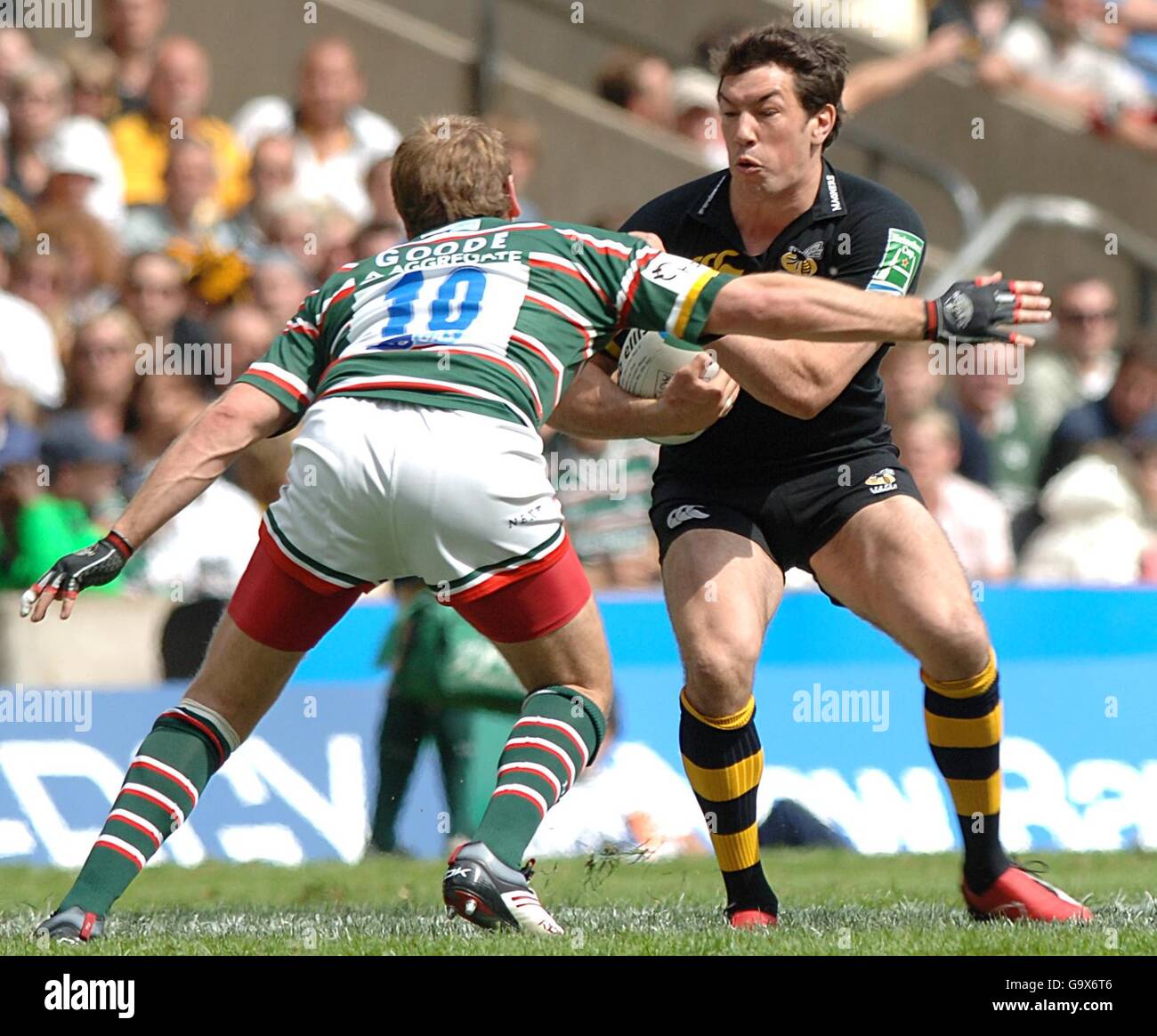 Leicester Tigers' Andy Goode trys to tackle London Wasps' Tom Voyce ...