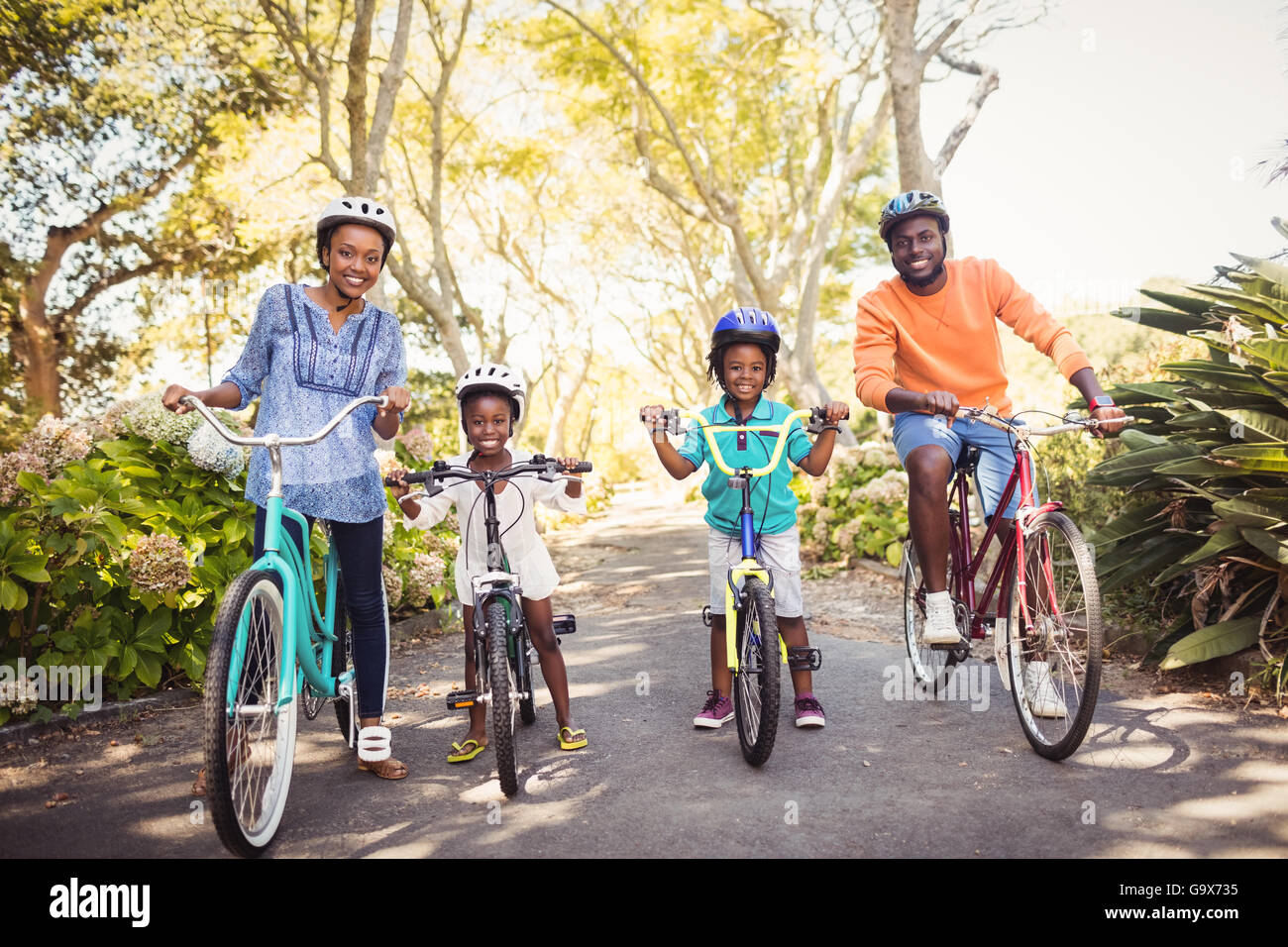 Happy family doing bicycle Stock Photo - Alamy