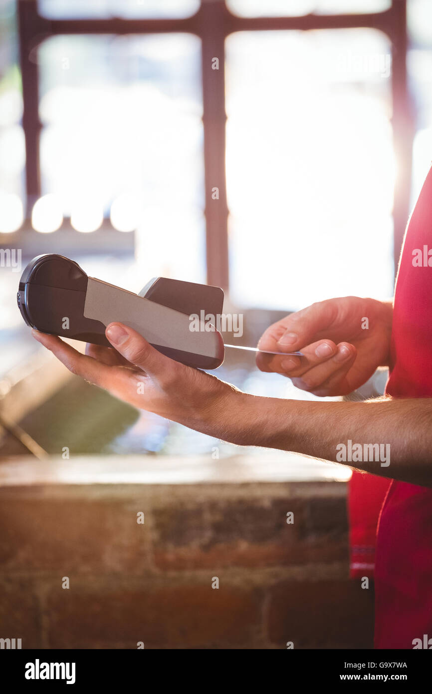 Waiter inserting customer's credit card into credit card machine Stock ...