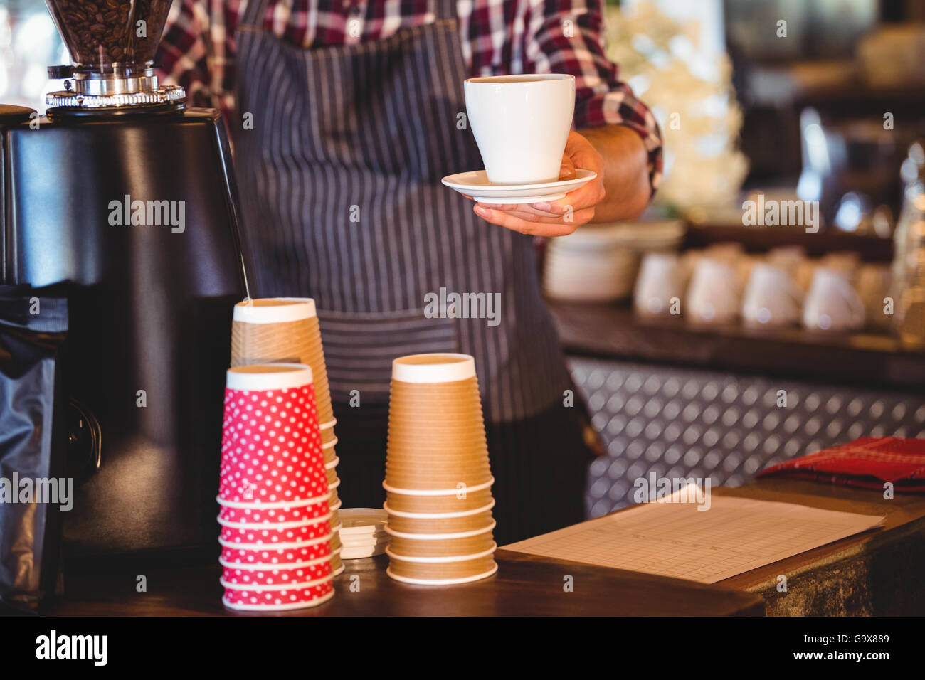 Waiter handing over a coffee Stock Photo - Alamy