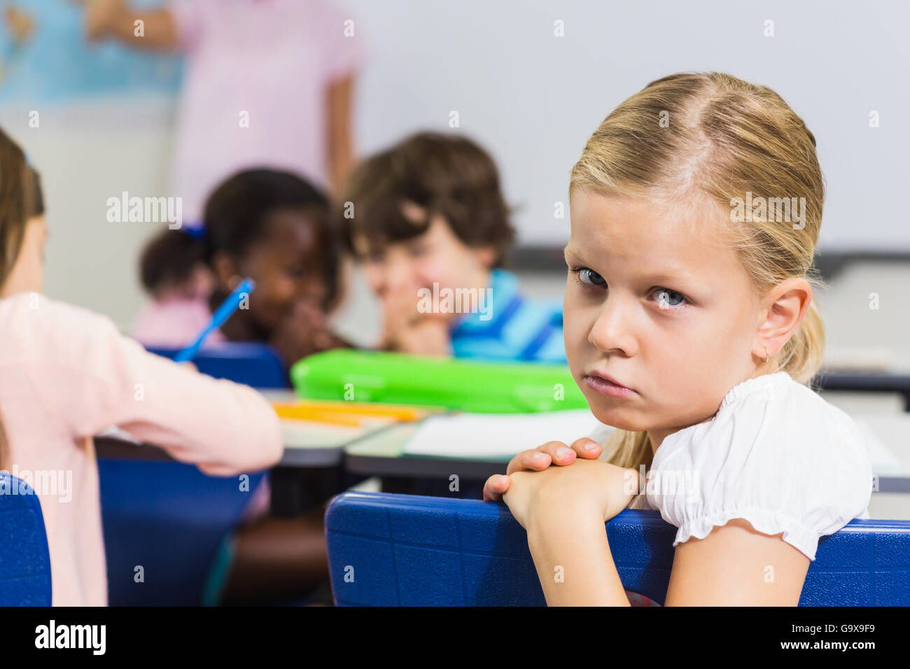 Sad girl sitting in classroom hi-res stock photography and images - Alamy