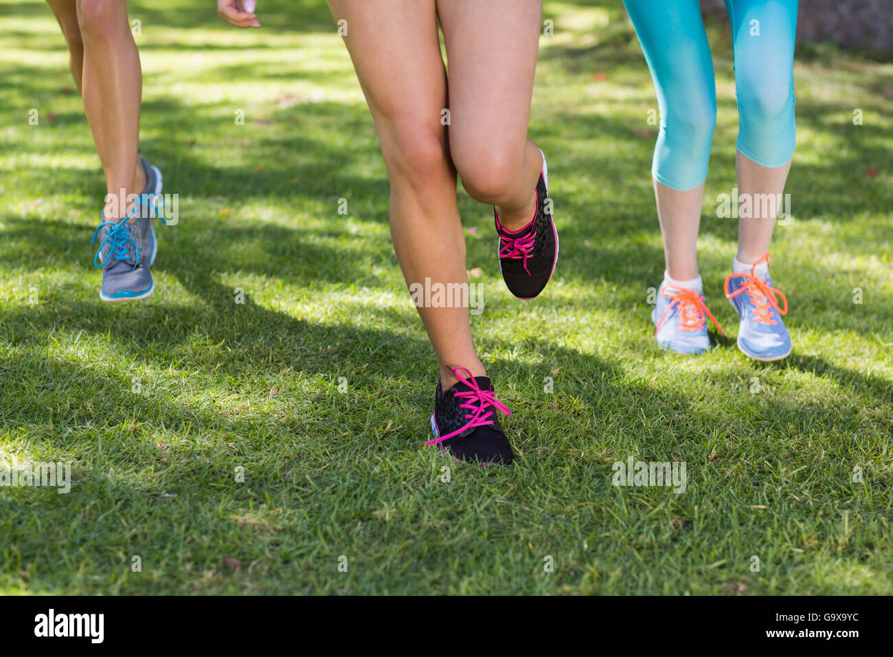 Female athlete feet running on grass Stock Photo - Alamy