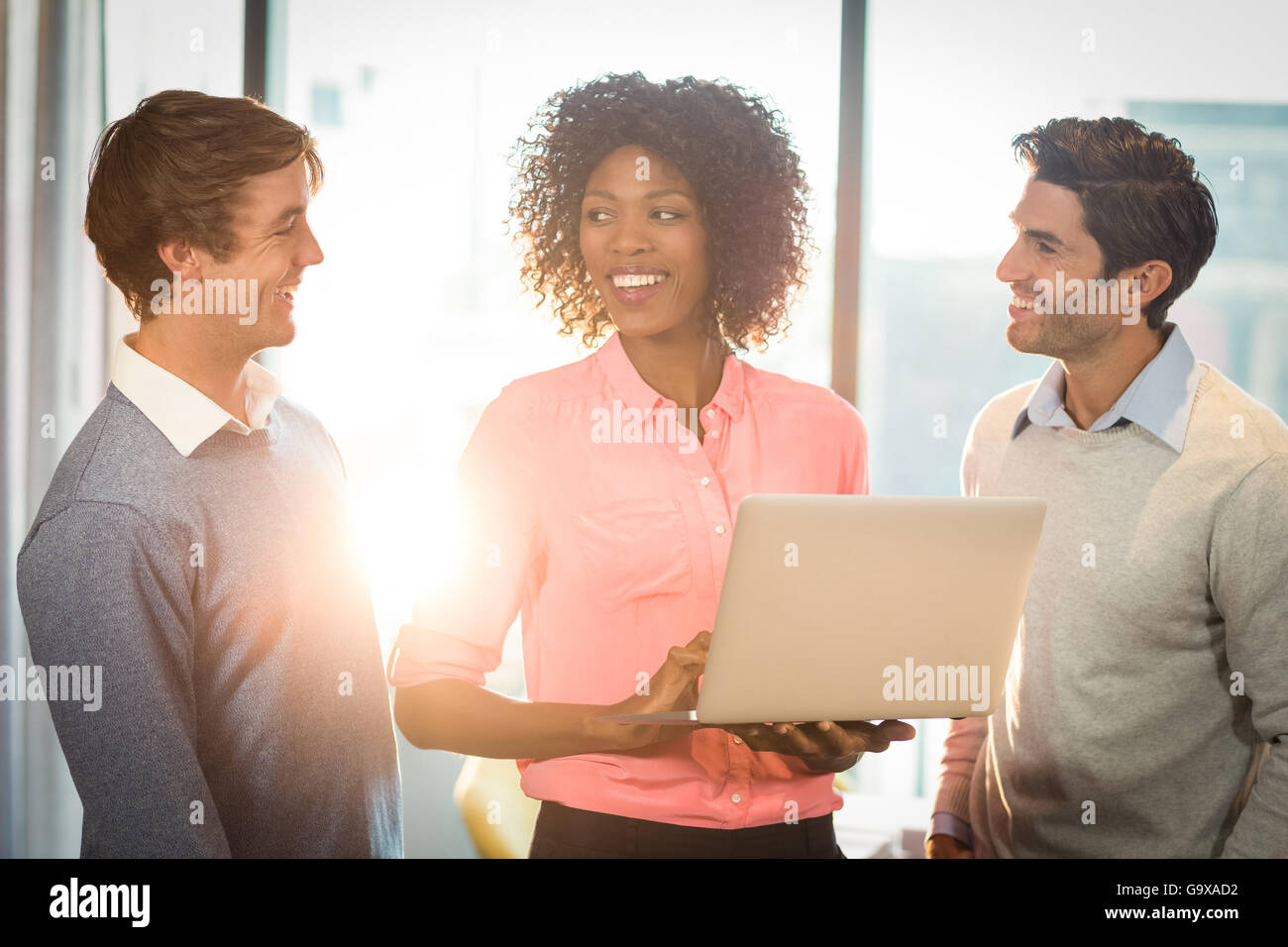 Business people discussing over laptop Stock Photo - Alamy