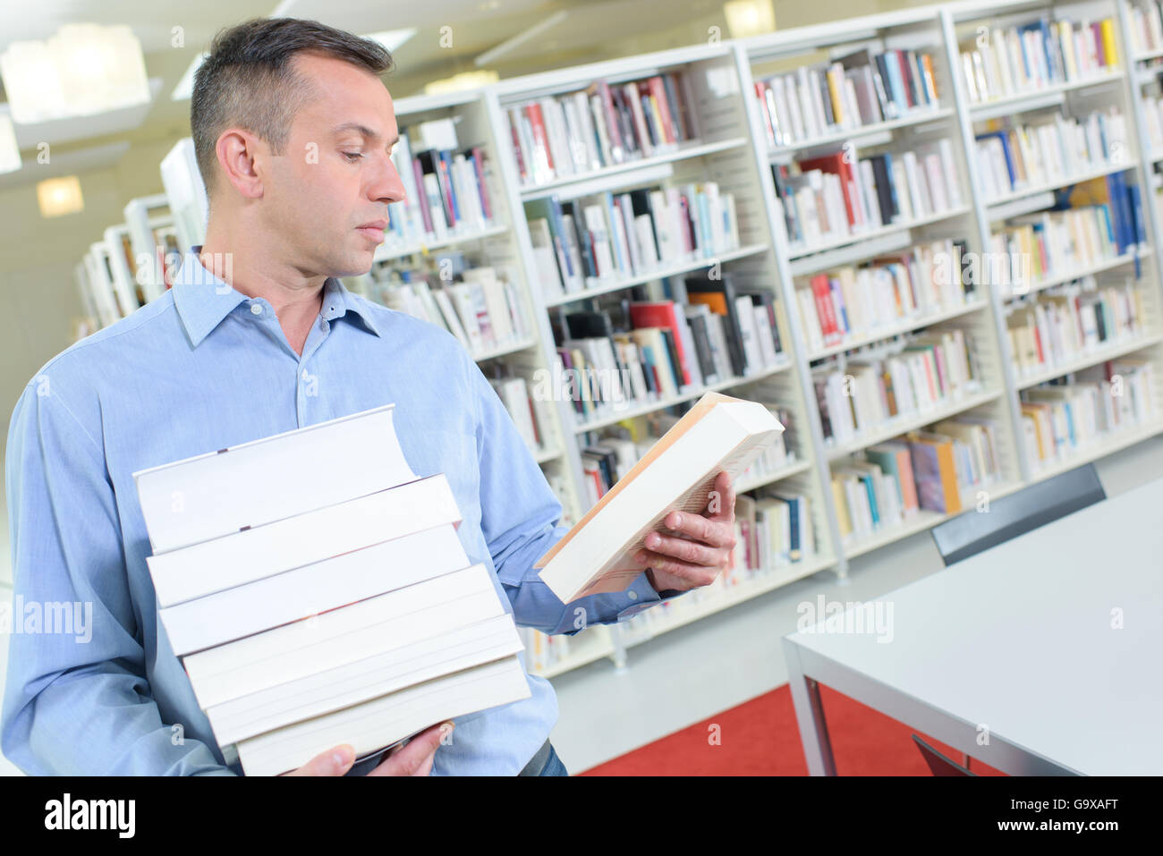 choosing a book Stock Photo - Alamy