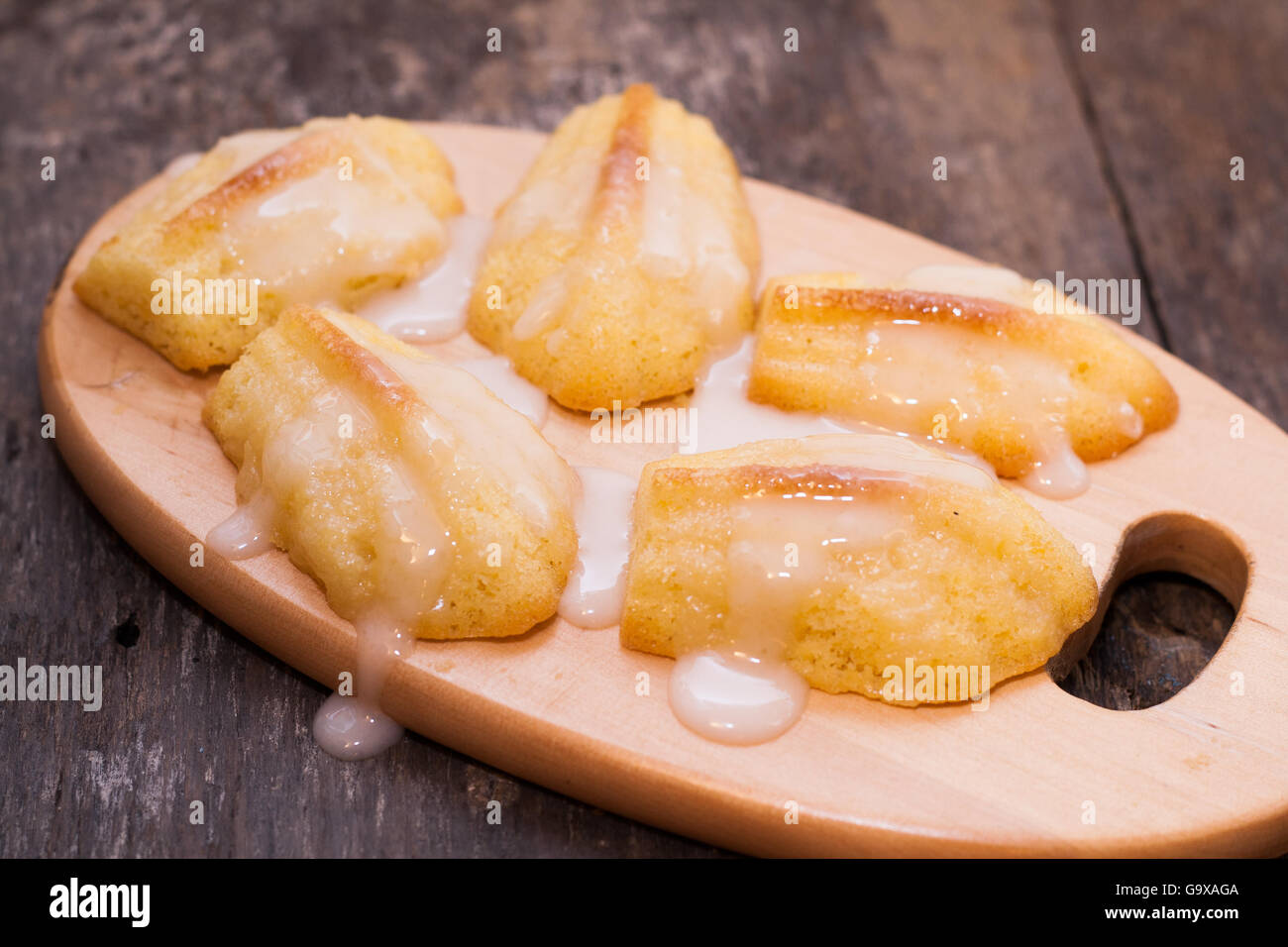 Cakes Madeleine poured icing on the grid Stock Photo - Alamy