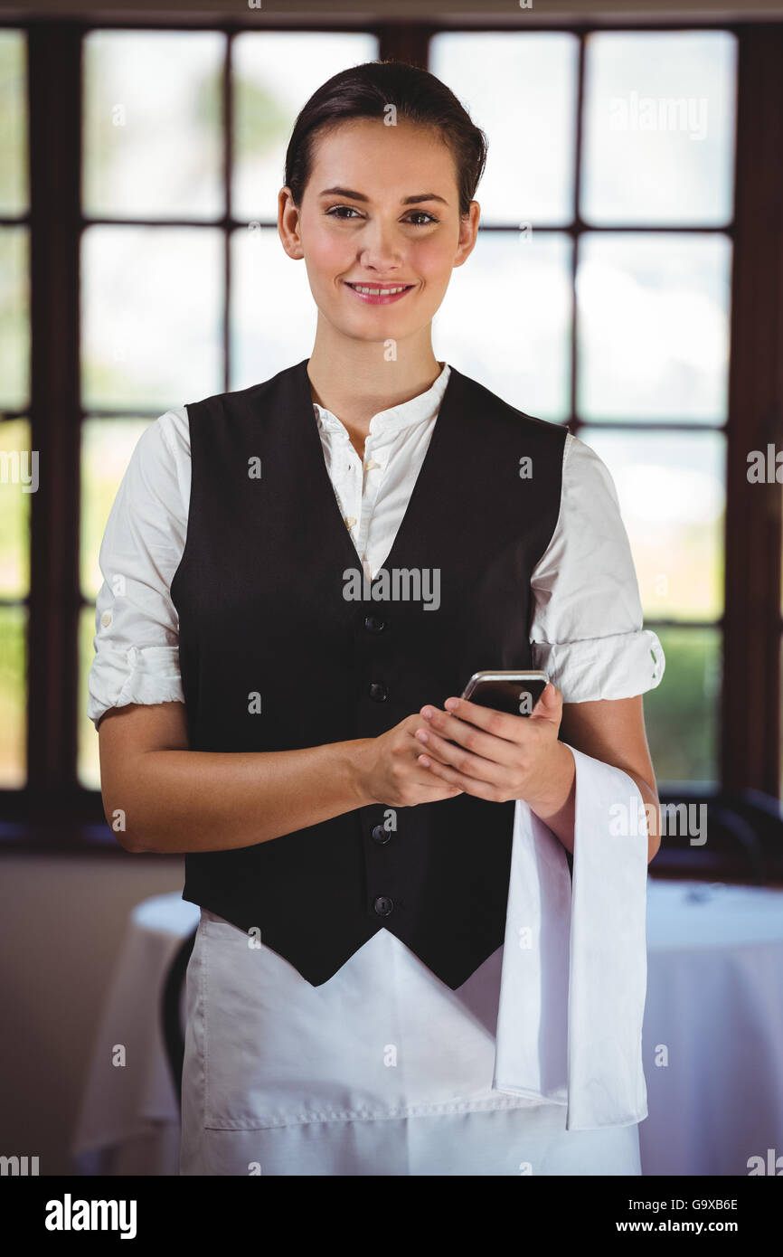 Waitress using mobile phone hi-res stock photography and images - Alamy