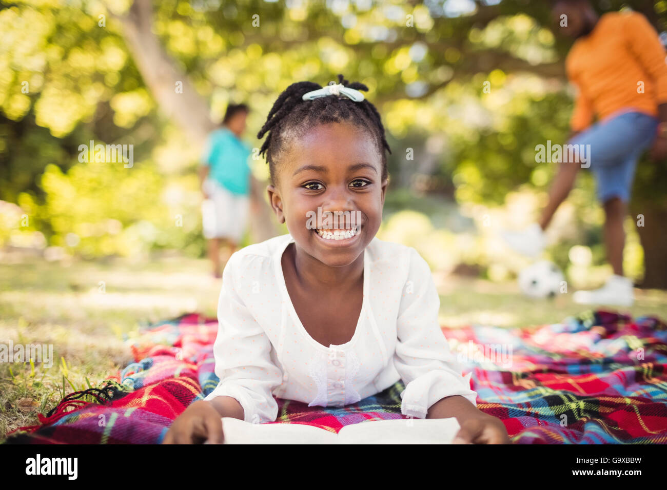 Happy girl reading a book Stock Photo - Alamy