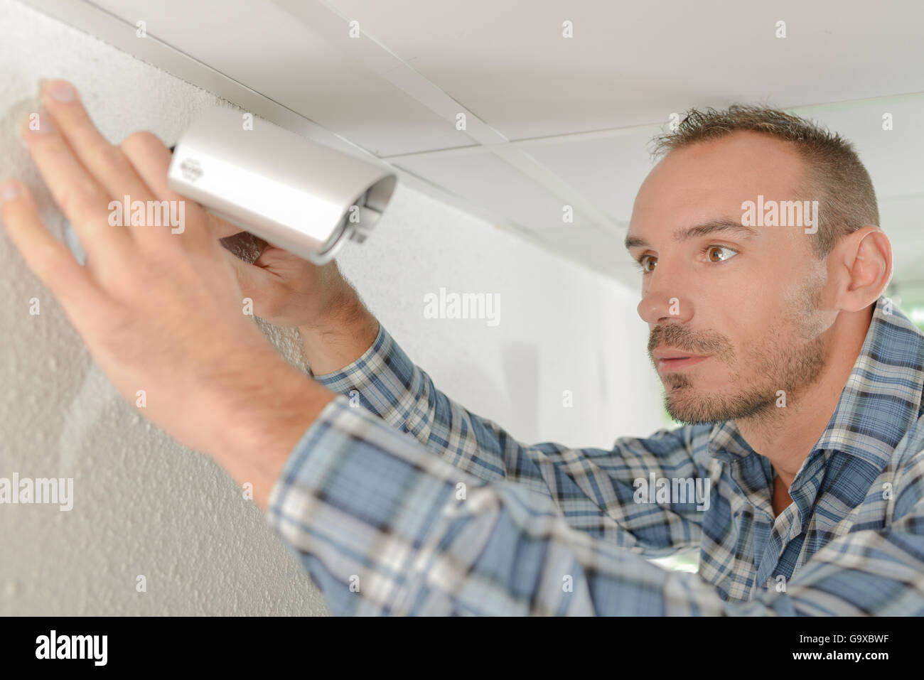 Fitting a security camera Stock Photo - Alamy