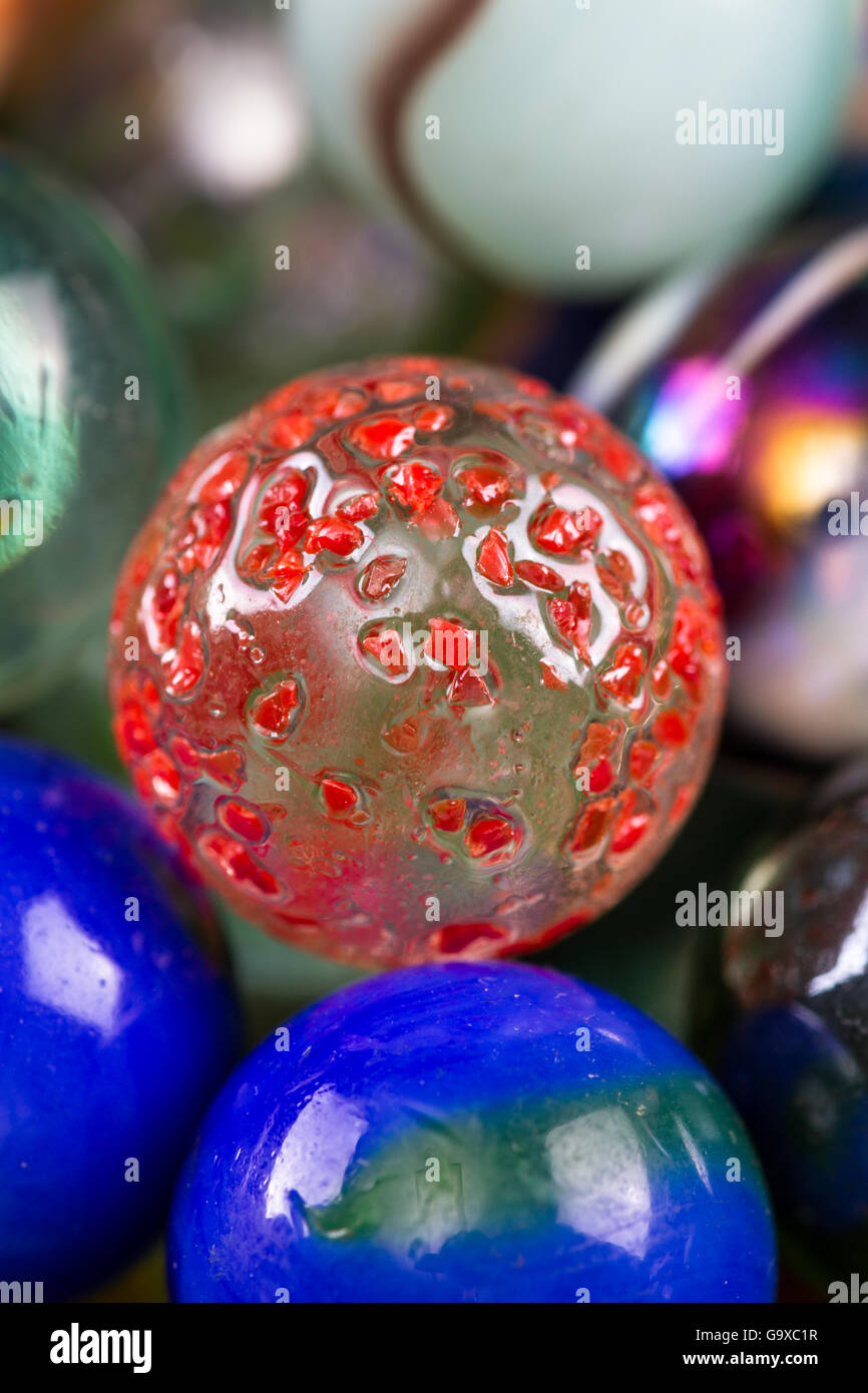 close up of a bunch of marbles in different colors for a background or ...
