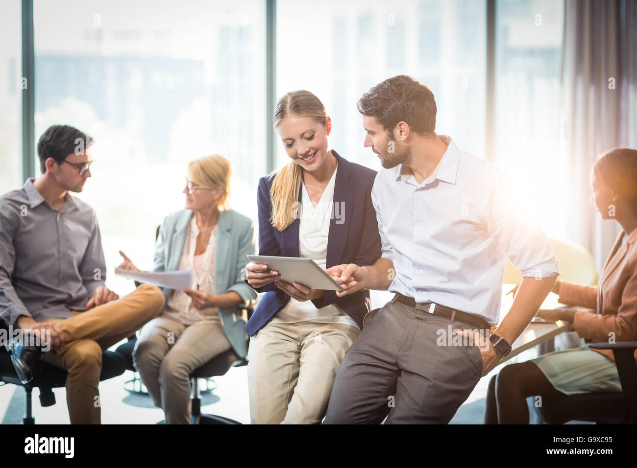 Business people interacting with each other Stock Photo - Alamy