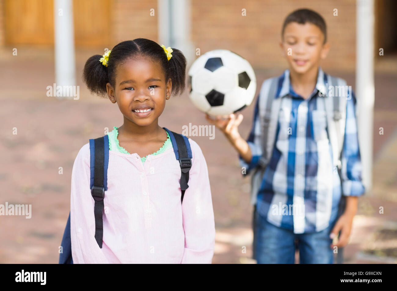 Smiling kids standing in at school Stock Photo - Alamy
