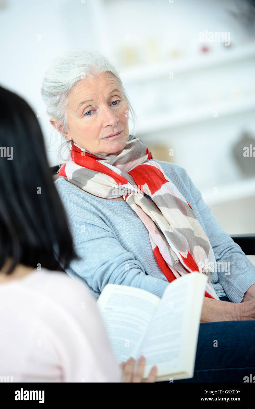 Helping senior woman to read Stock Photo - Alamy