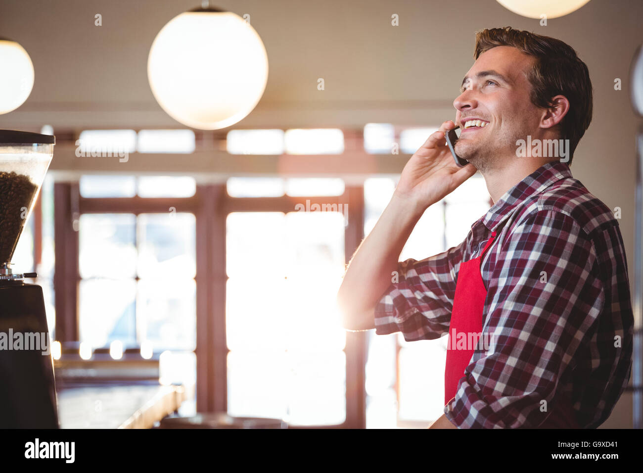 Waiter talking on mobile phone Stock Photo - Alamy