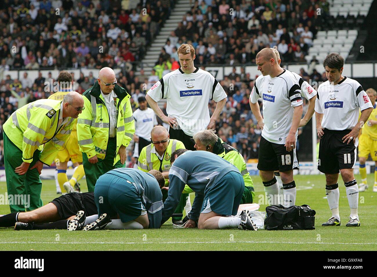 Derby County players look on as referee Phil Crossley receives ...