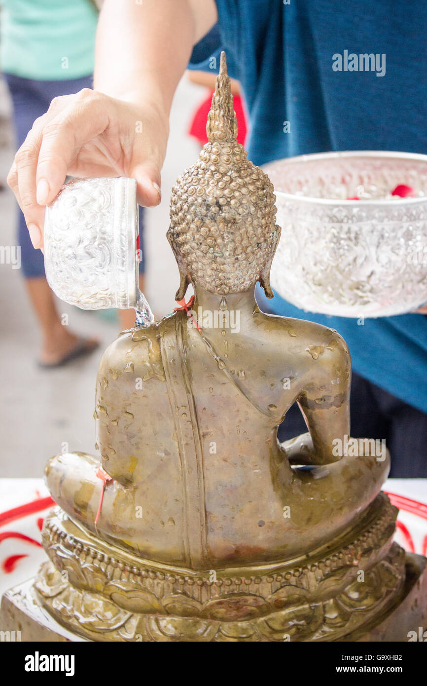 sprinkle water onto statue of Buddha Stock Photo - Alamy