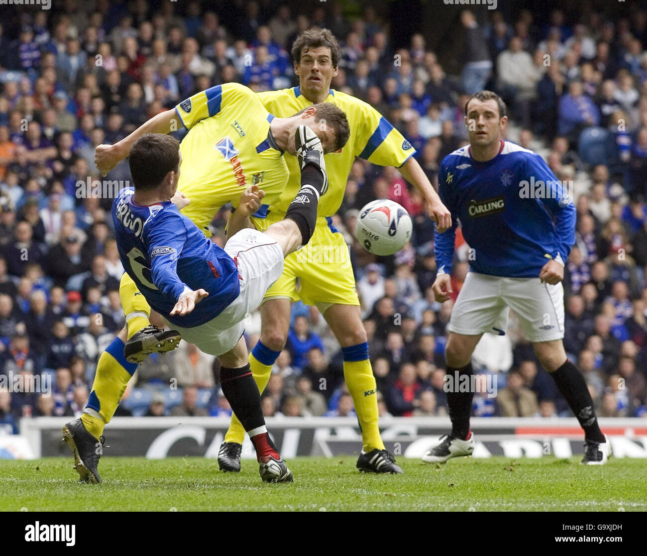 Rangers' Barry Ferguson (left) of Rangers has his overhead kick cleared ...