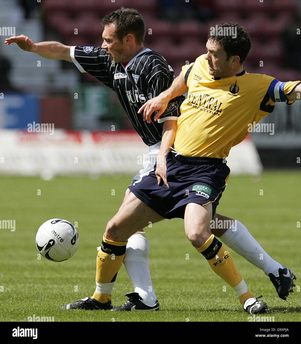 Dunfermline's Darren Young and Falkirk's Steven Thomson balttle for the ...